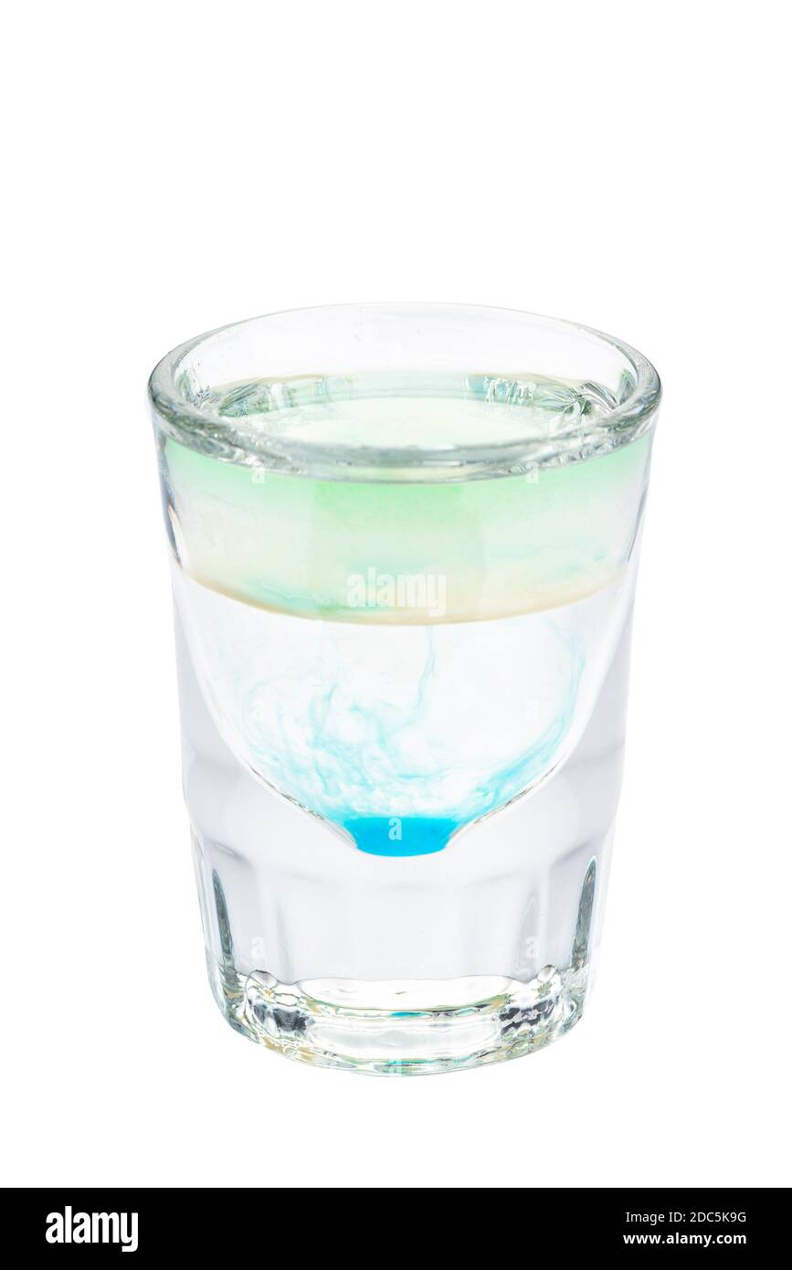 Alcohol shots cocktail in a glass isolated on white background. Layered ...