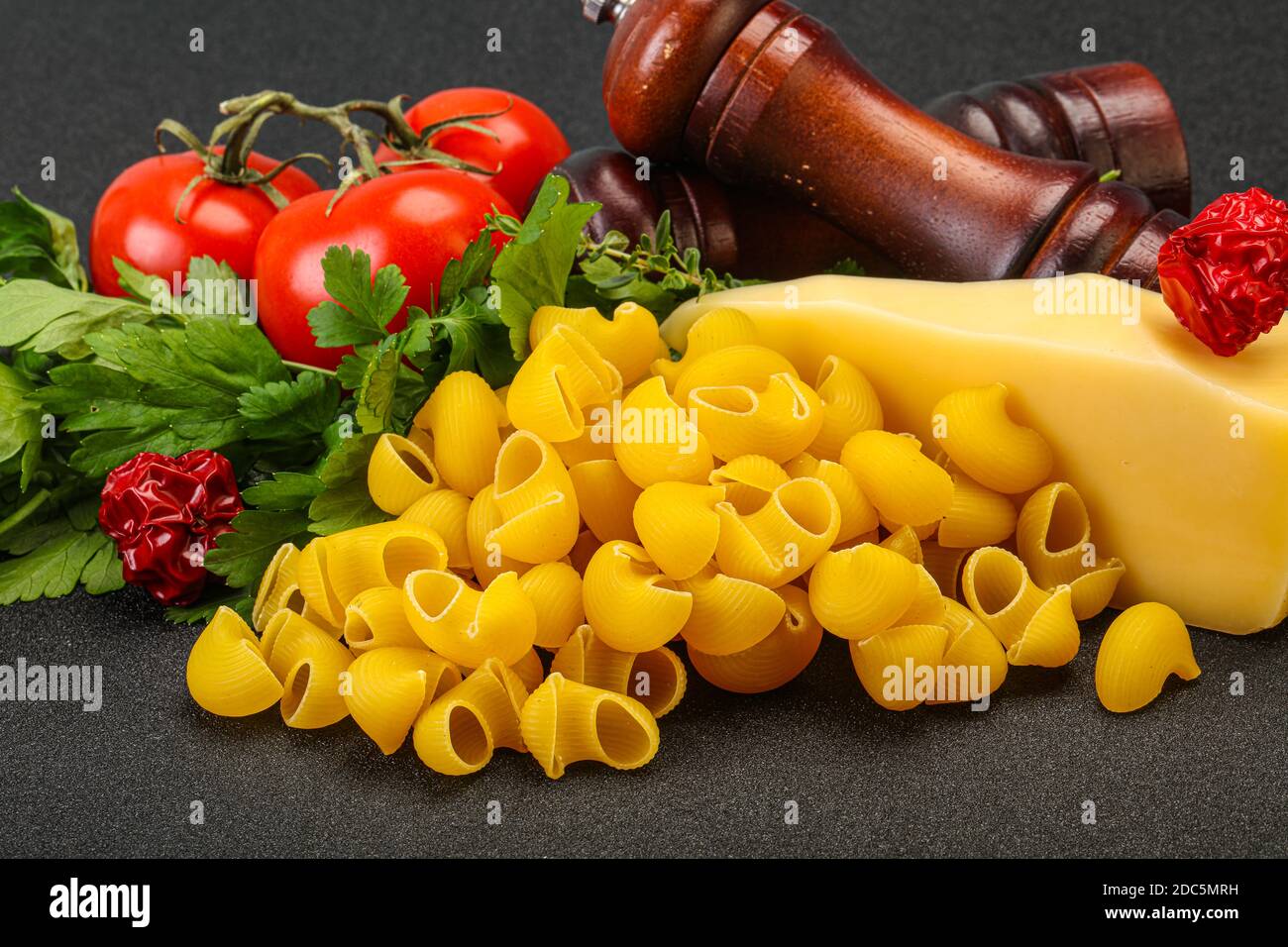 Italian pasta - raw pipe rigate served vegetables Stock Photo - Alamy
