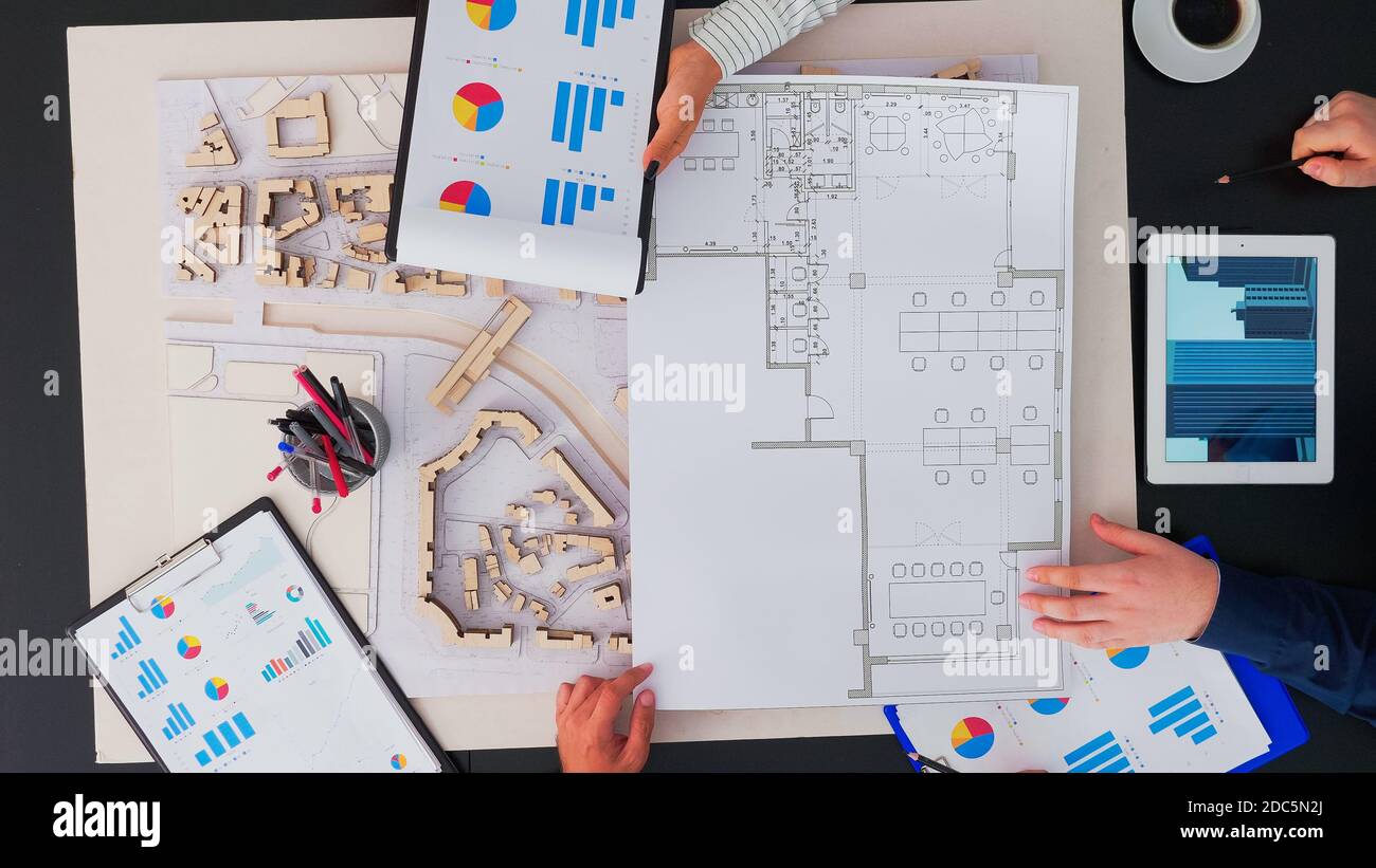 Top view of businesspeople team of architects with buildings prototype ...
