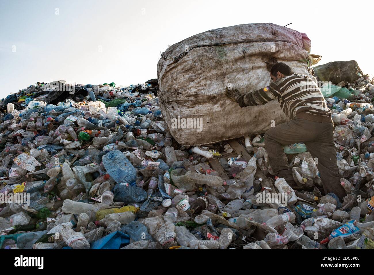 A Romi worker selects bottles and other plastic containers collected in ...