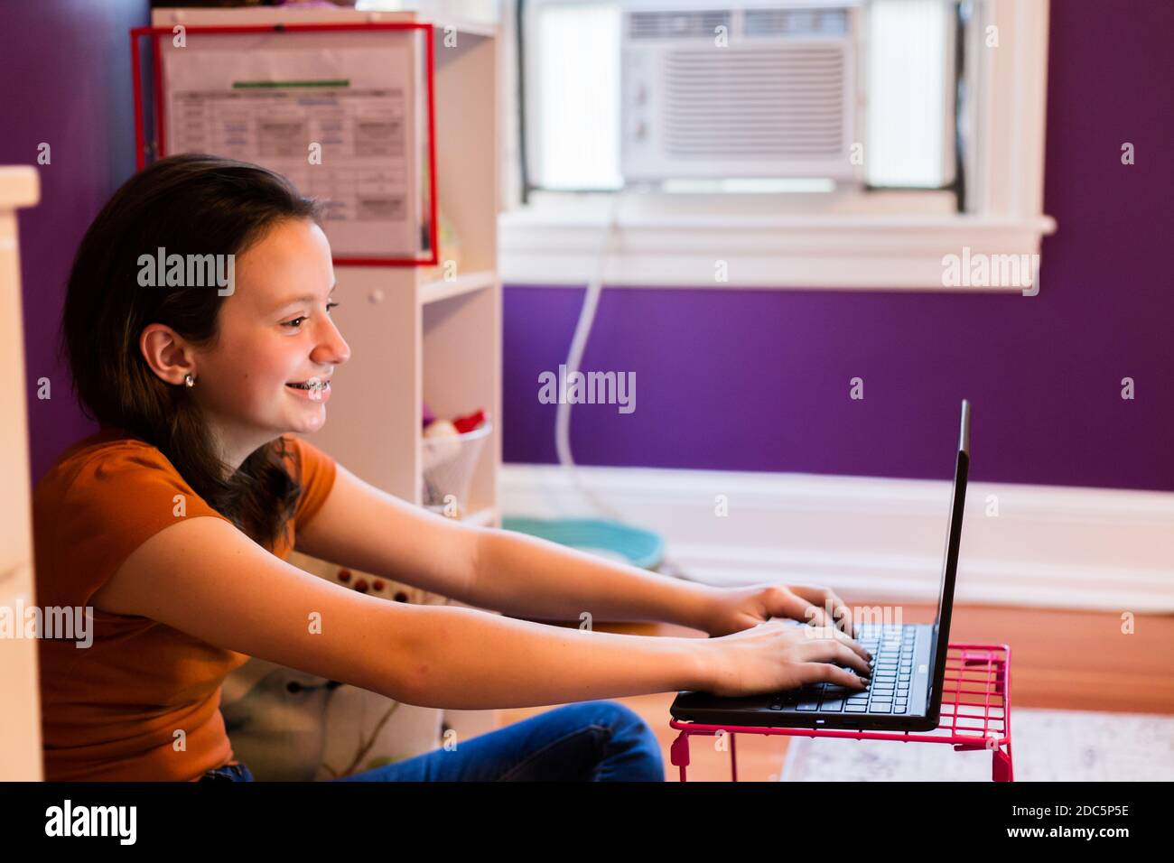 Teenage girl using computer Homeschool smiling at computer screen Stock ...