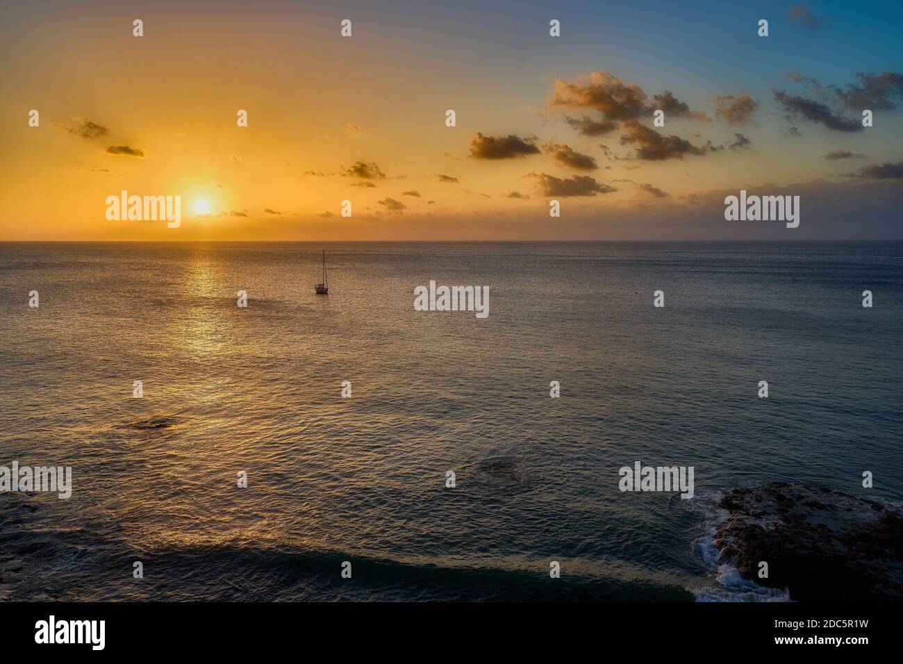 the open sea with a single ship at sunset Stock Photo - Alamy