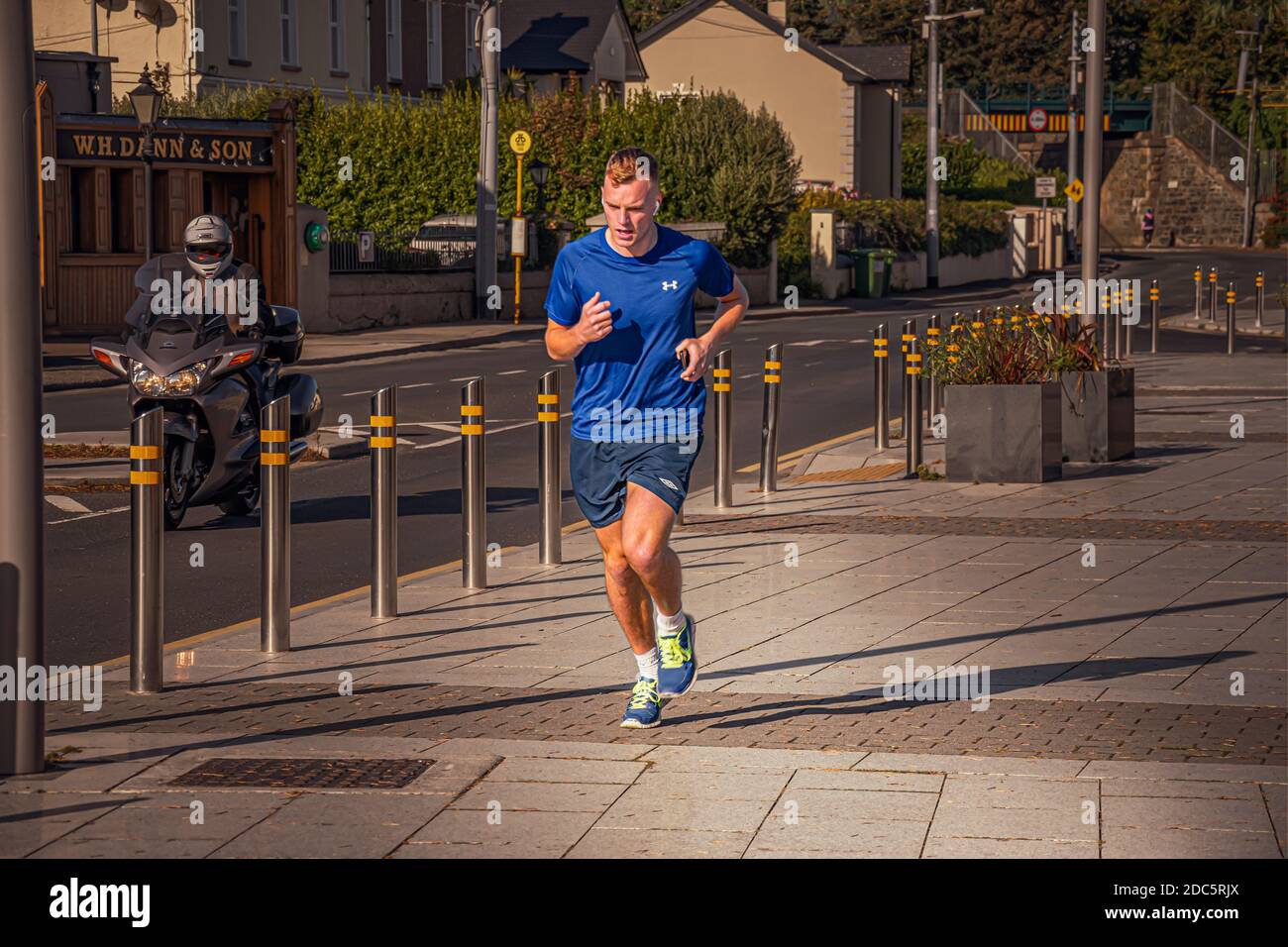 Everyday life. Young man doing hard running as his morning exercise ...
