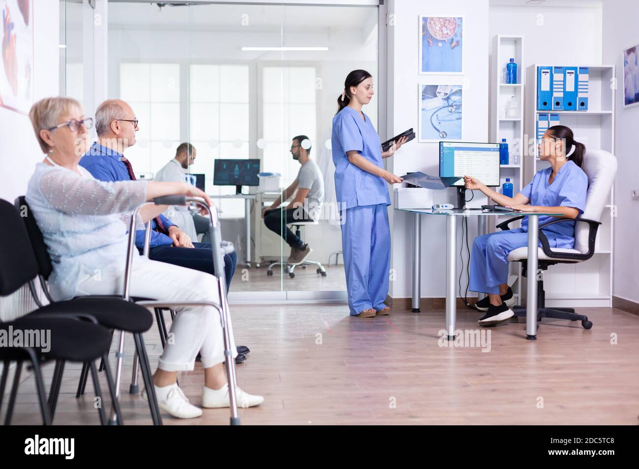 Senior woman with walking frame in hospital waiting room for ...