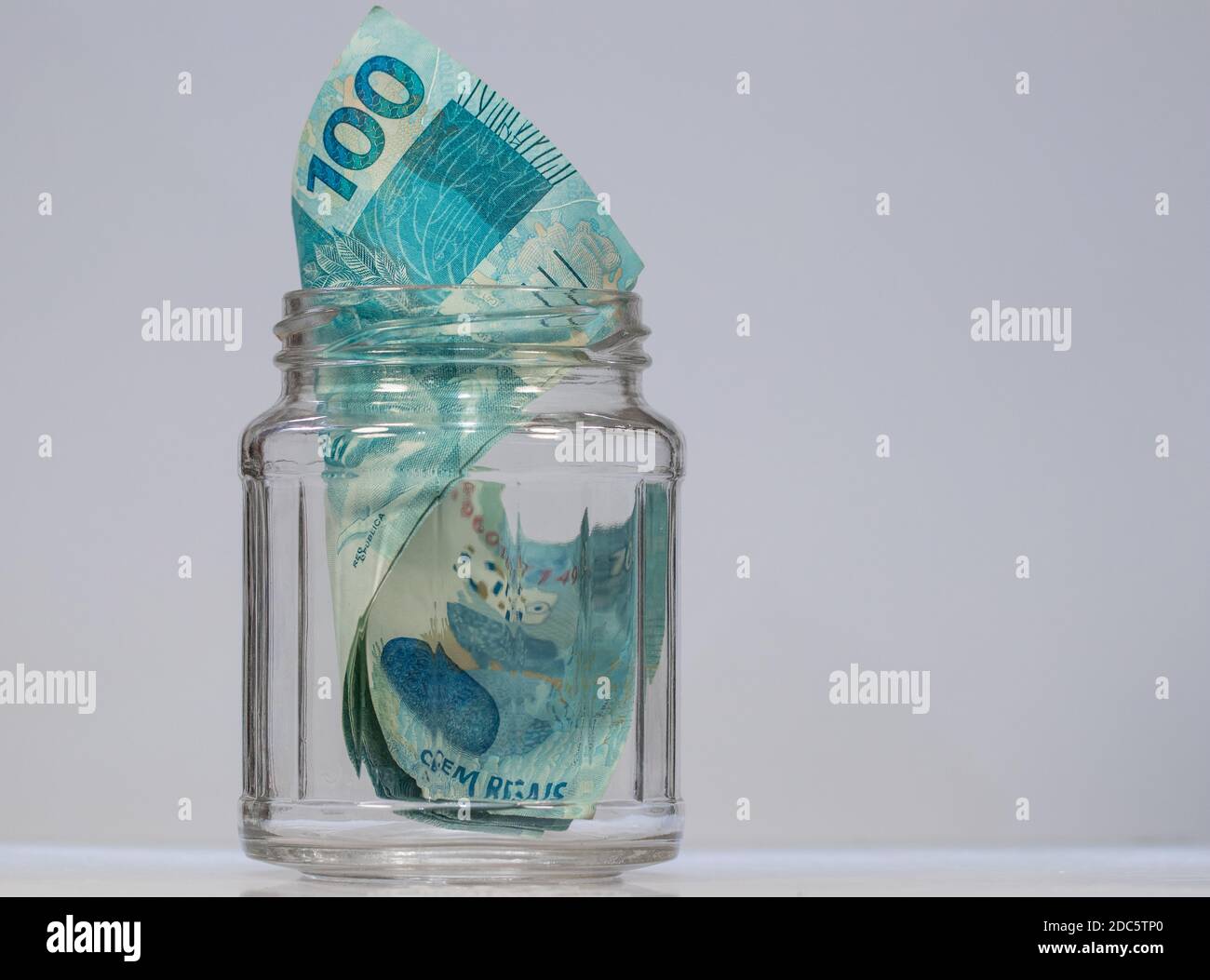 A closeup shot of a Brazilian real bill in the glass bank Stock Photo ...
