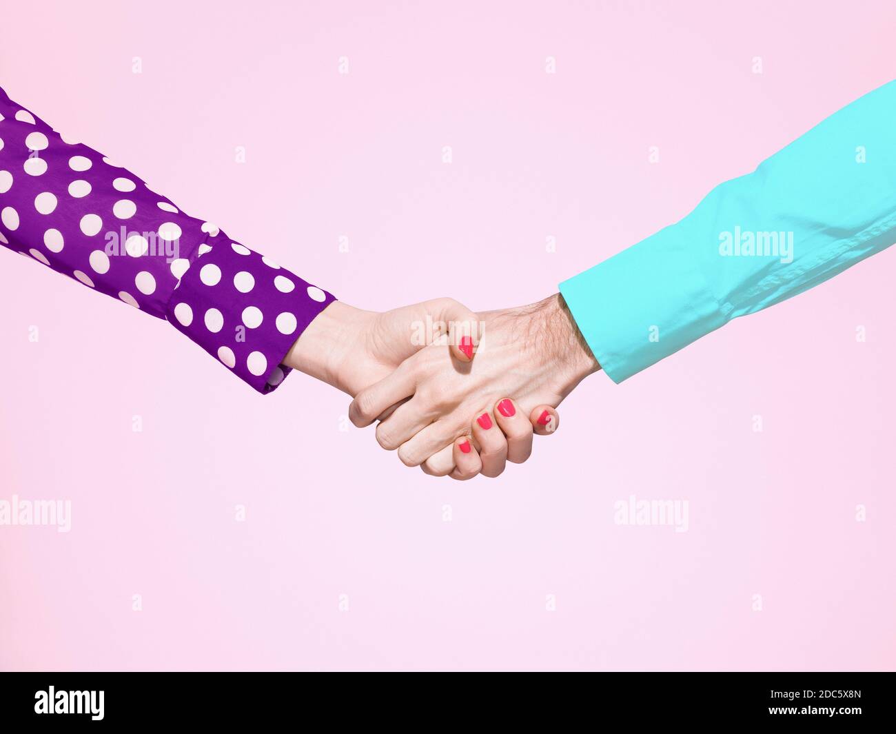 Vibrant handshake on pink background Stock Photo - Alamy