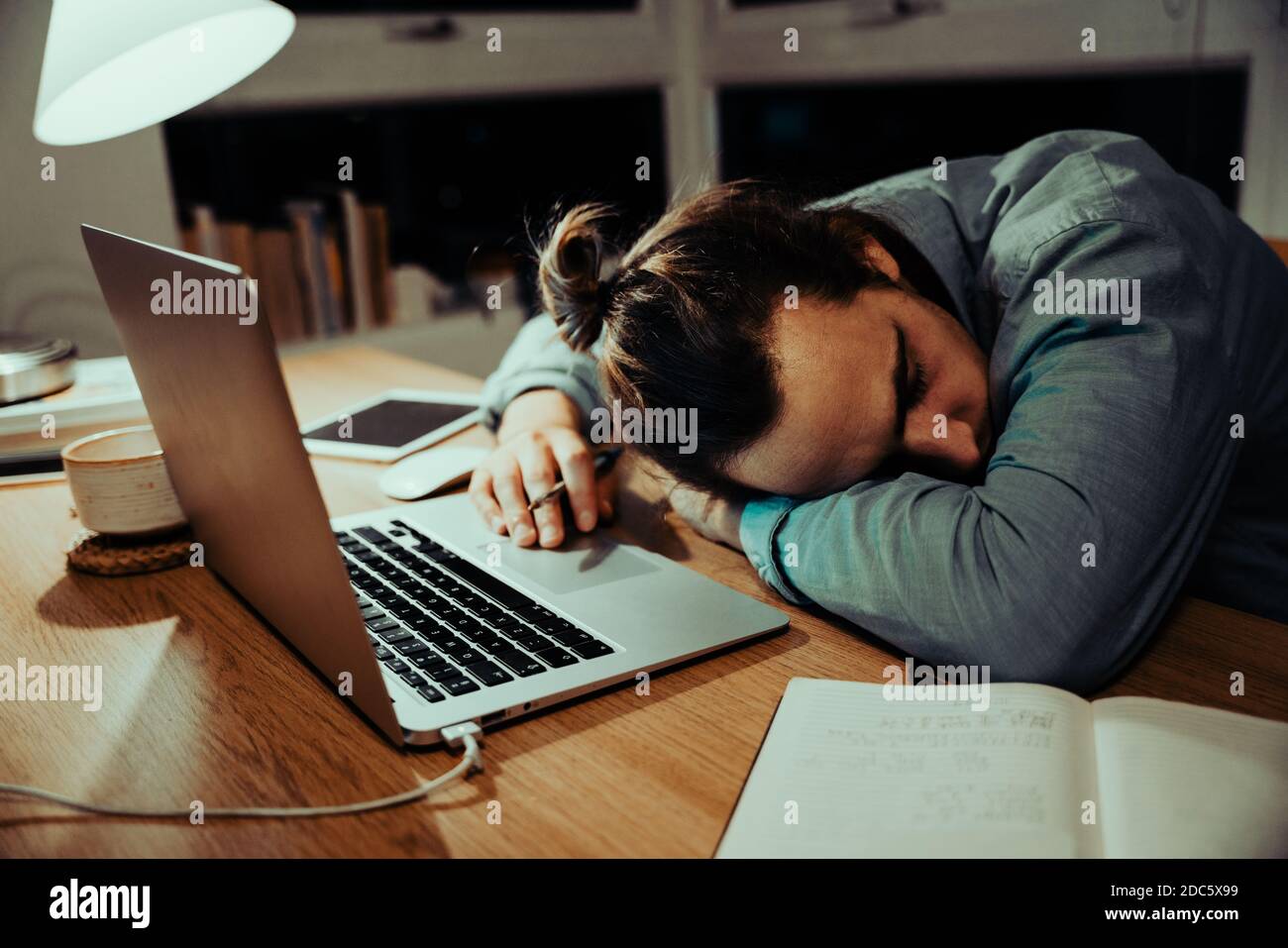 Tired caucasian businessman sleeping at office desk after a long night ...