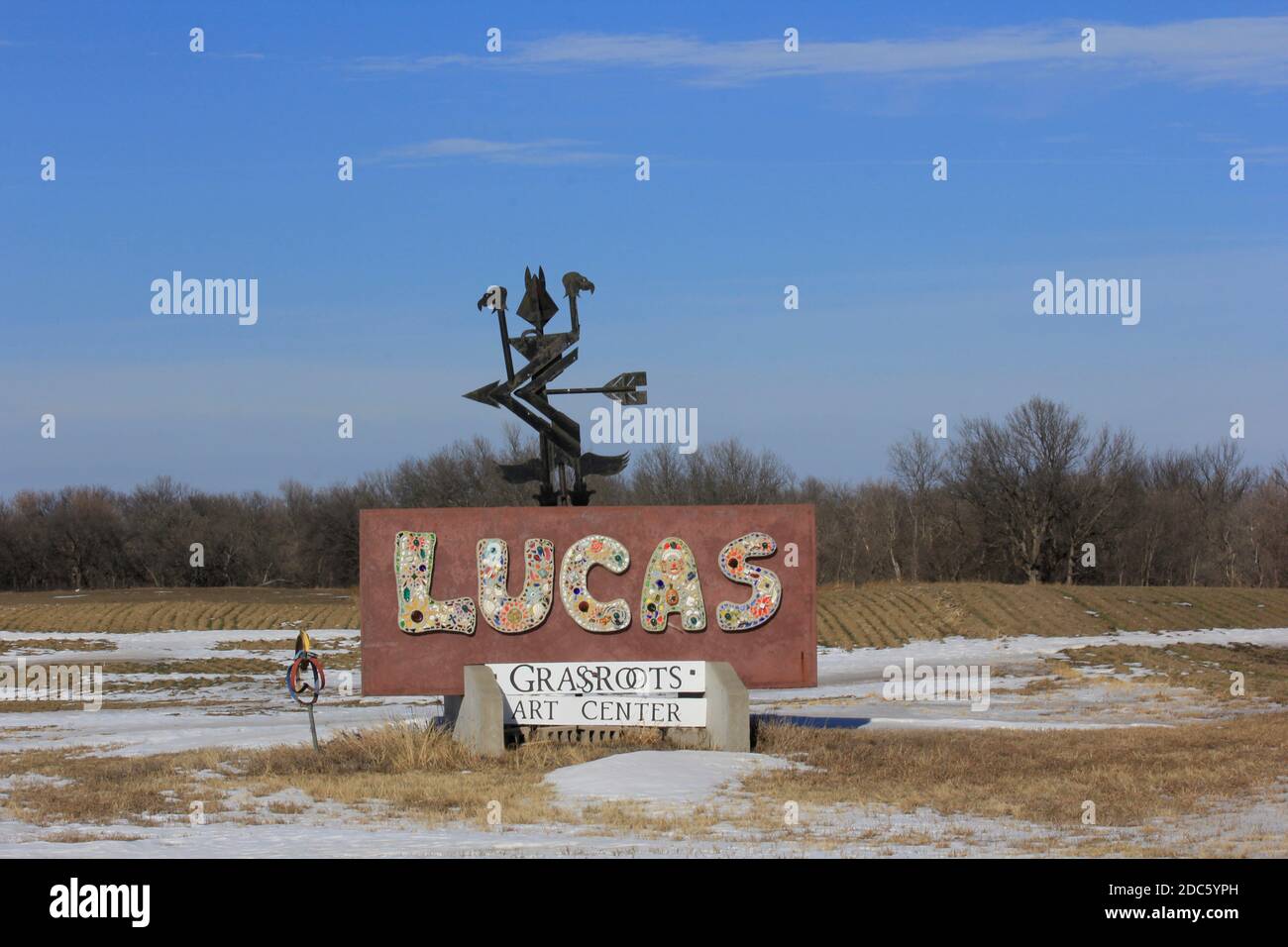 Lucas Kansas road sign by K 18 Highway with blue sky, tree's and snow ...