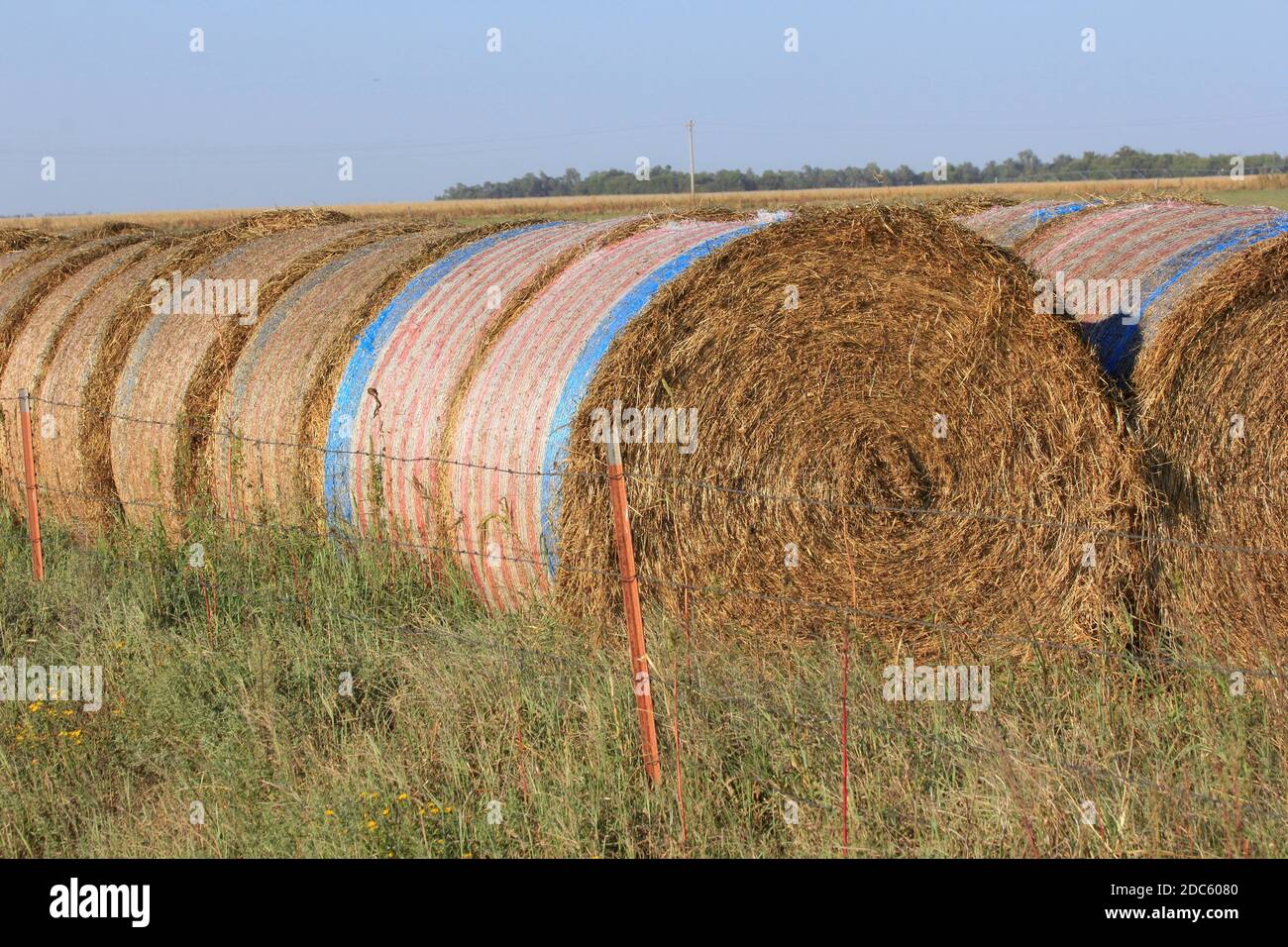 Kansas Hay Bales out in the country that are Red White and Blue with ...