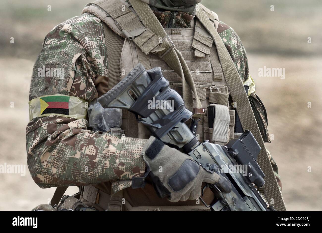 Soldier with assault rifle and flag of Azawad on military uniform ...