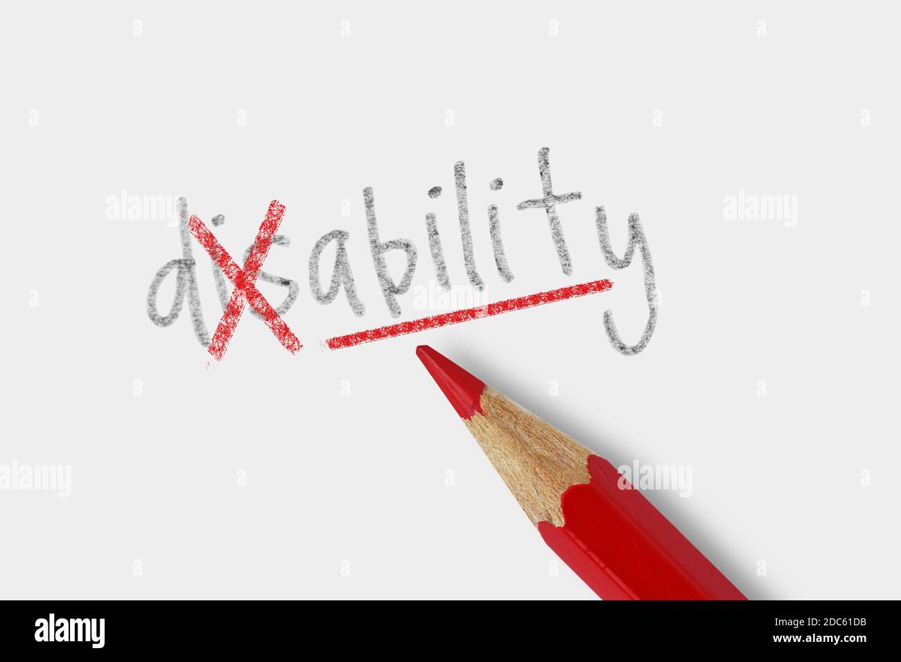 The word disable corrected with red pencil on white background ...