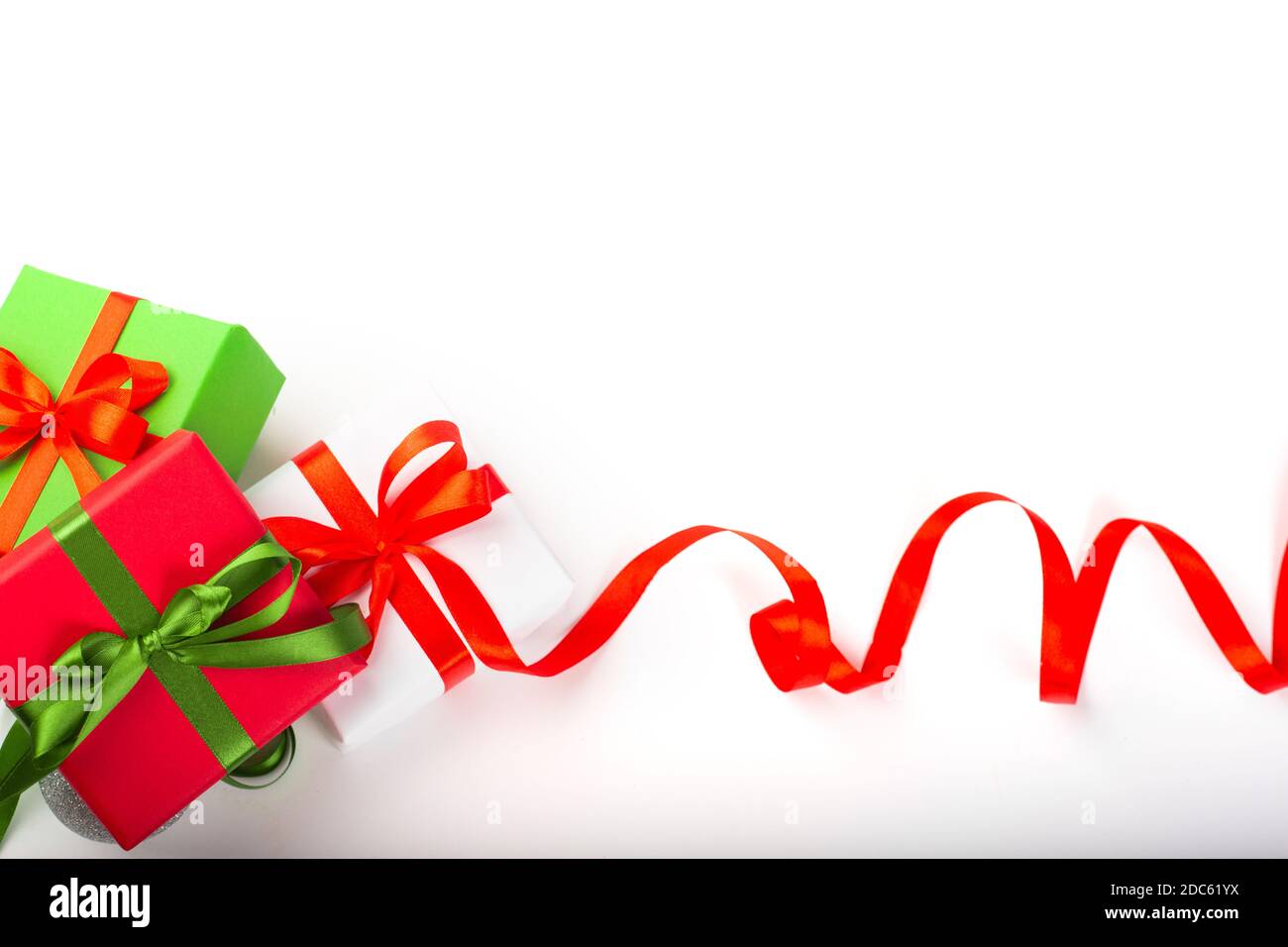 Holiday present gift boxes with red satin bow and curly ribbon border ...