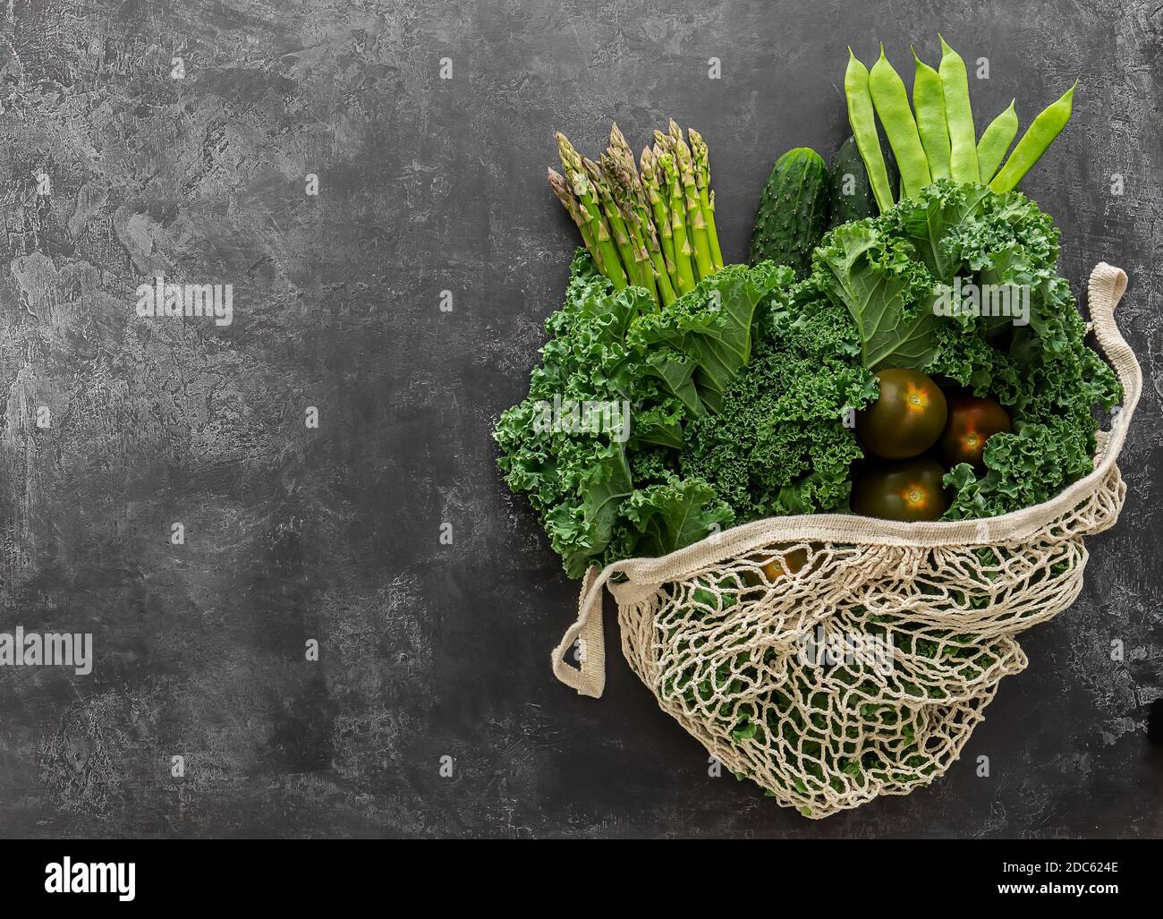 Green vegetables in the string bag. Asparagus, broccolini, kale ...