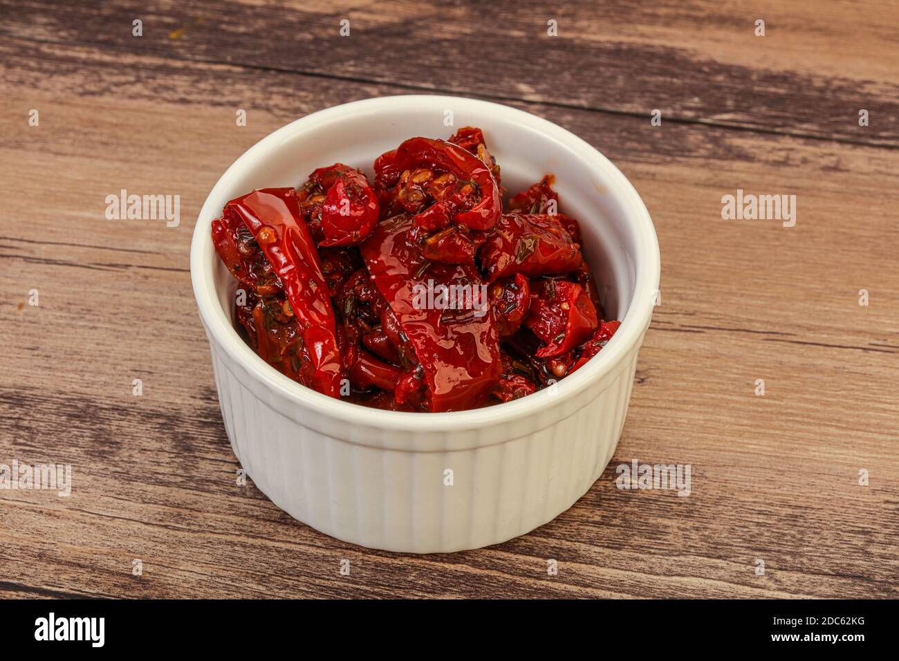 Dried tomato with olive oil and herbs Stock Photo - Alamy