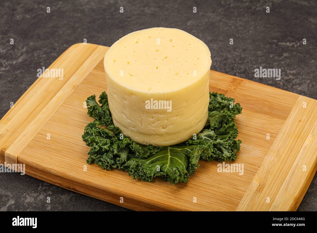 Yellow round dairy soft cheese piece Stock Photo - Alamy
