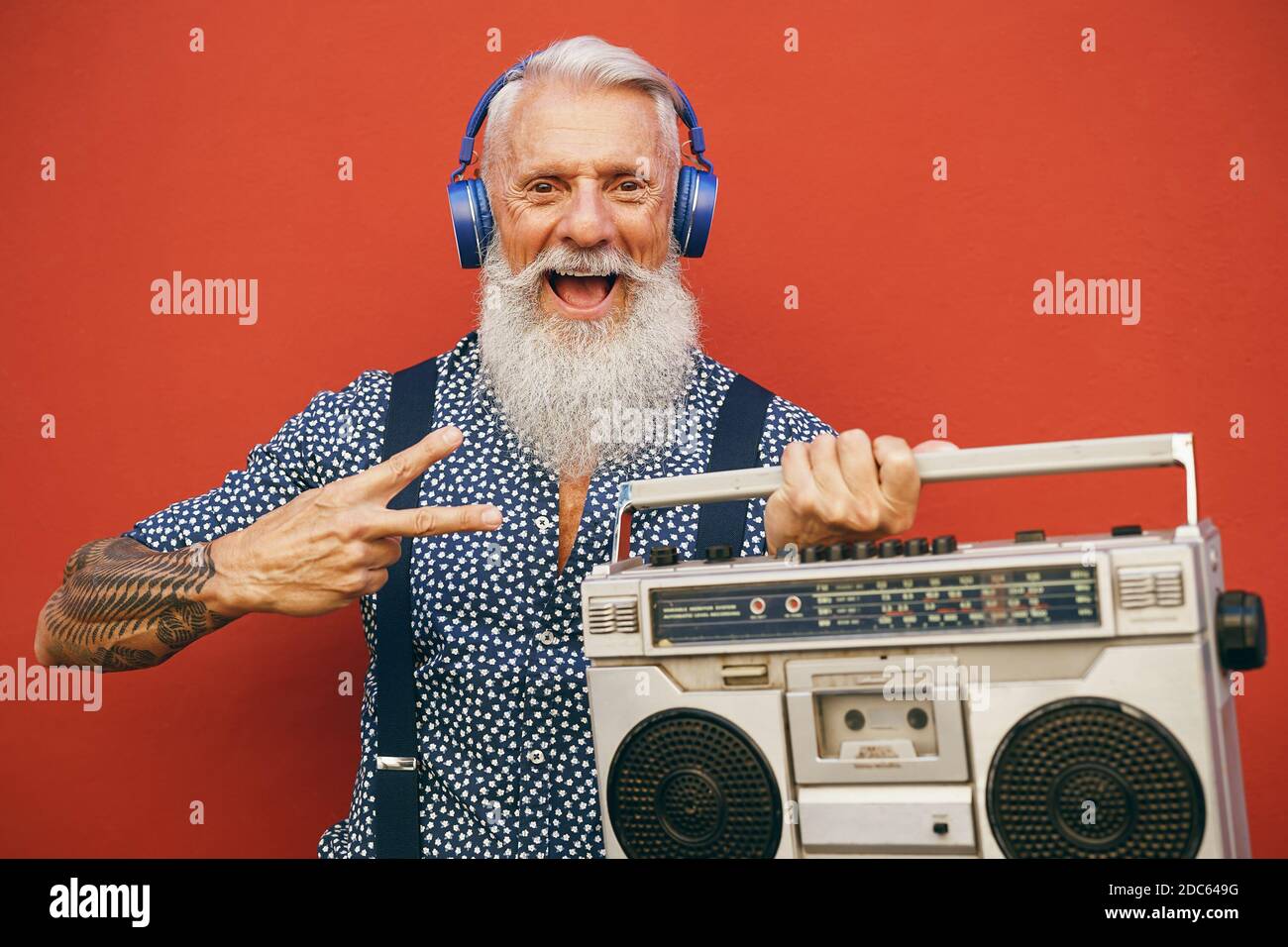 Happy Senior Man Listening To Music With Wireless Headphones And