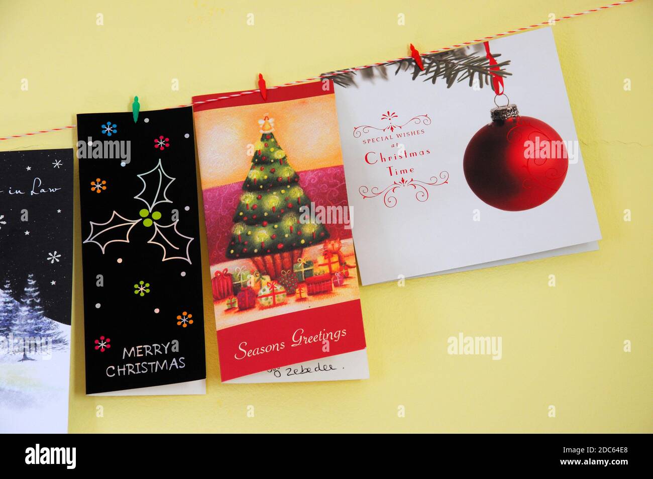 Row of Christmas cards hanging on a string Stock Photo - Alamy