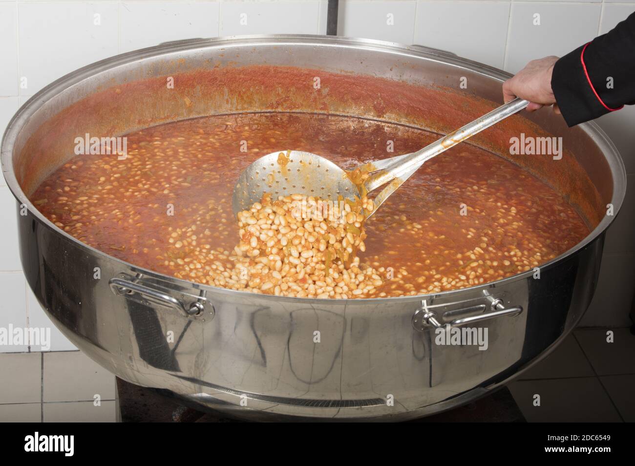 A chef cooking beans in a commercial kitchen Stock Photo - Alamy