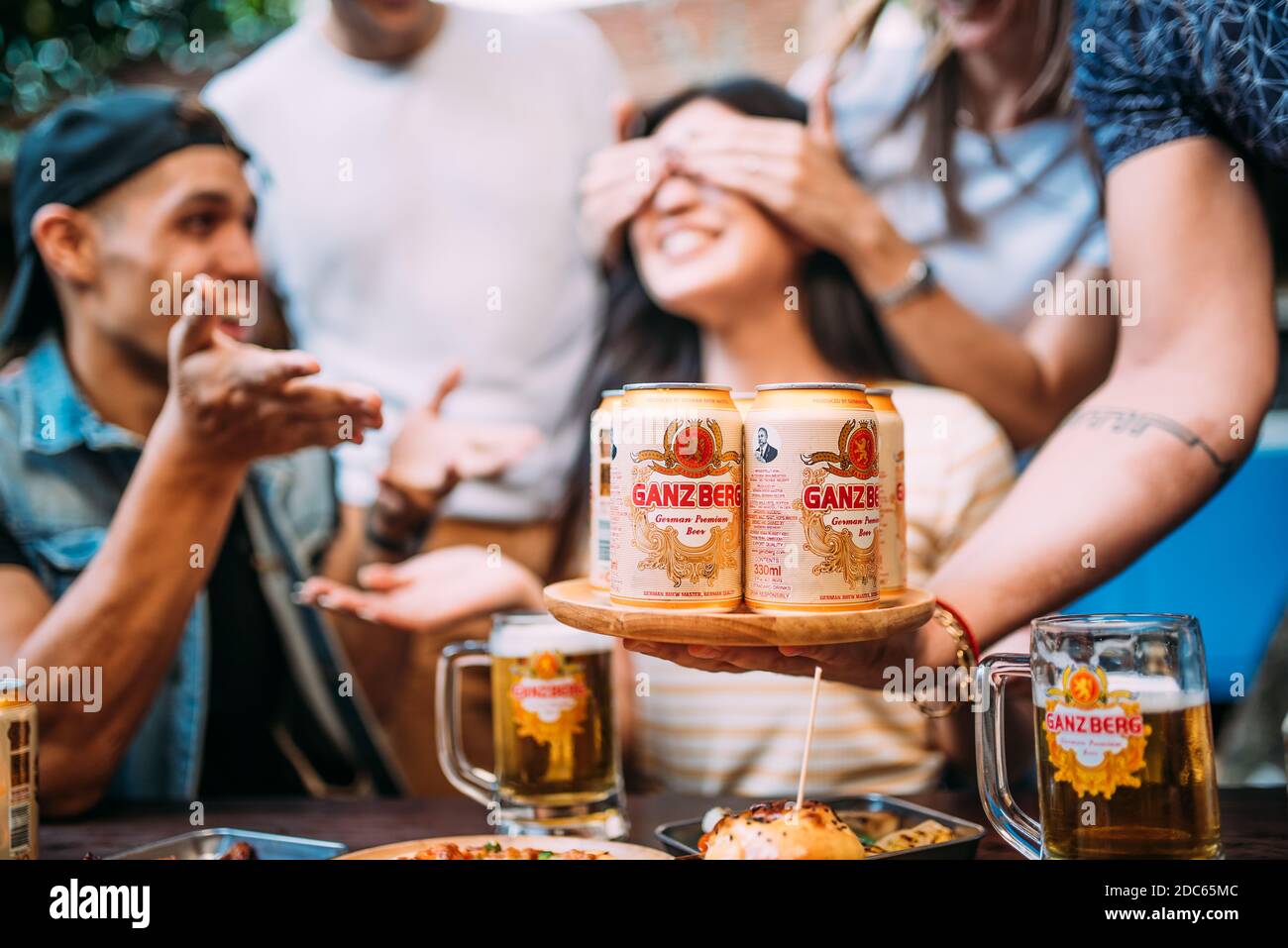 Beer Party - Young couple enjoying hot summer day at a rooftop party ...