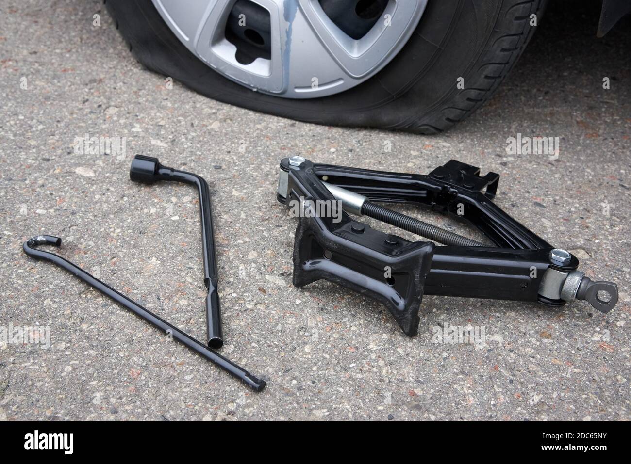 Flat tire of a passenger car, wheel replacement tools, trouble on the ...