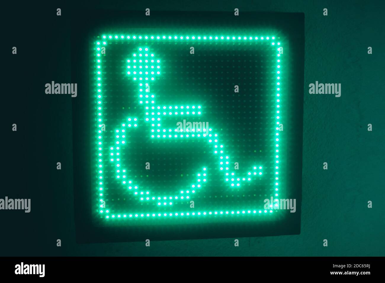 glowing green sign disabled on a black Stock Photo - Alamy
