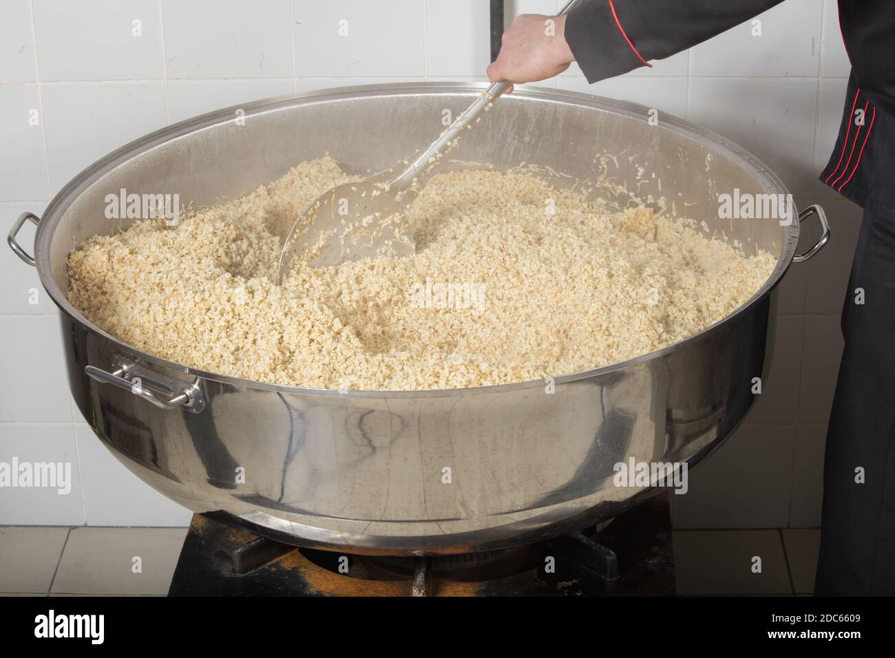 A chef cooking rice at a commercial kitchen Stock Photo - Alamy