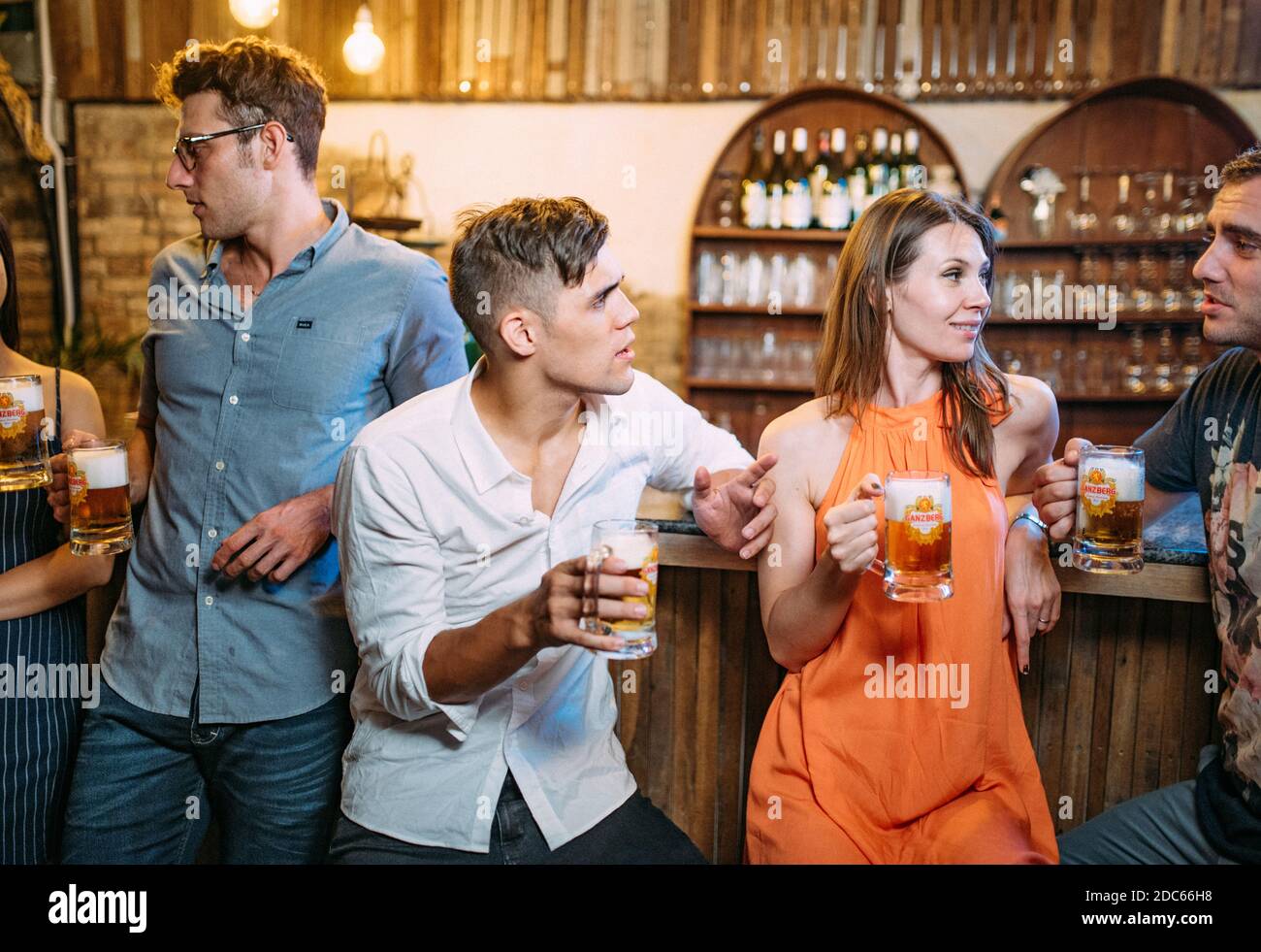 Beer Party - Young couple enjoying hot summer day at a rooftop party ...