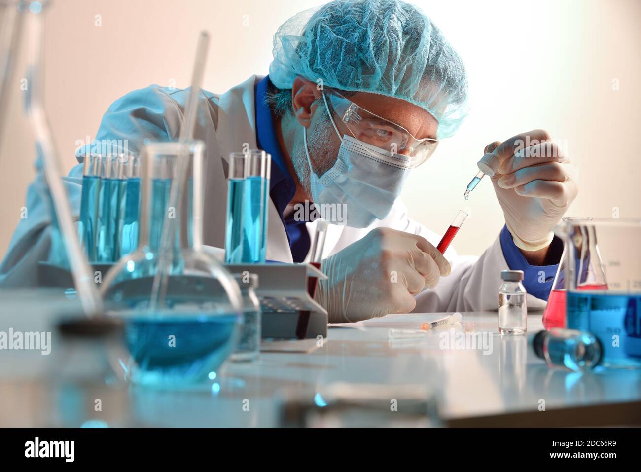 Microbiologist mixing reagent with sample in laboratory. Horizontal ...