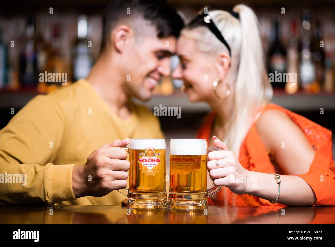 Beer Party - Young couple enjoying hot summer day at a rooftop party ...