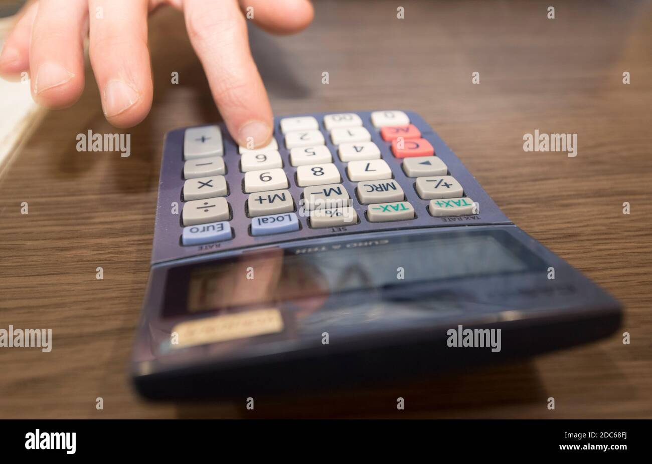 typing numbers in a pocket calculator with a LCD display Stock Photo ...