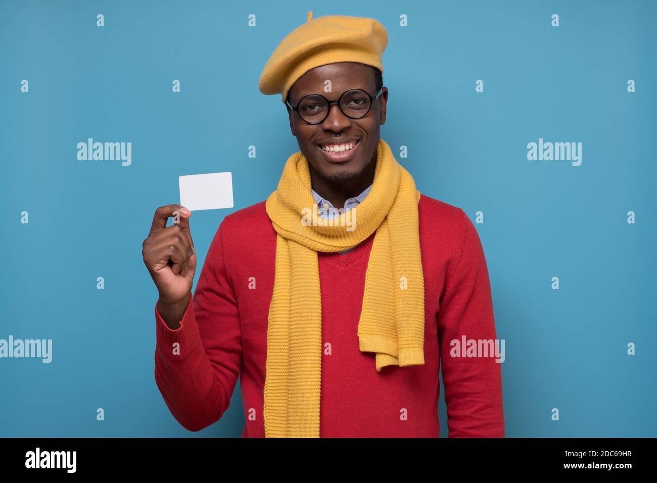 African American man holding a empty business card smiling. Advertise ...