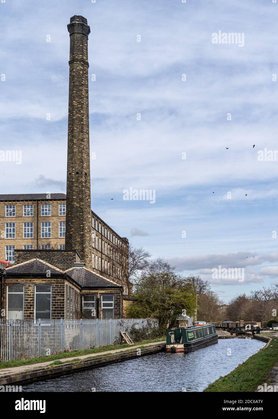 woollen mill, factory chimney and barge on the huddersfield narrow ...