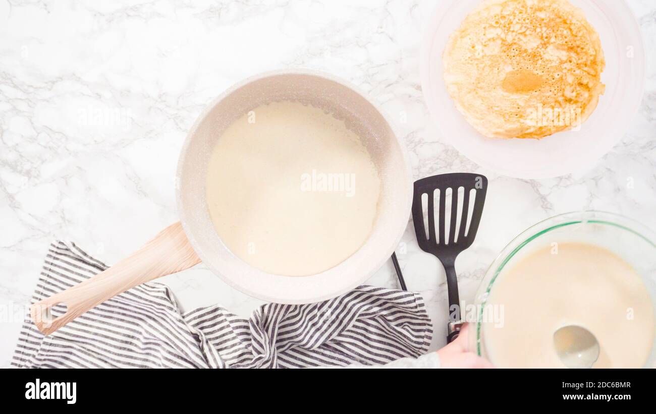 Flat lay. Making crepes in a small frying pan over medium heat Stock ...