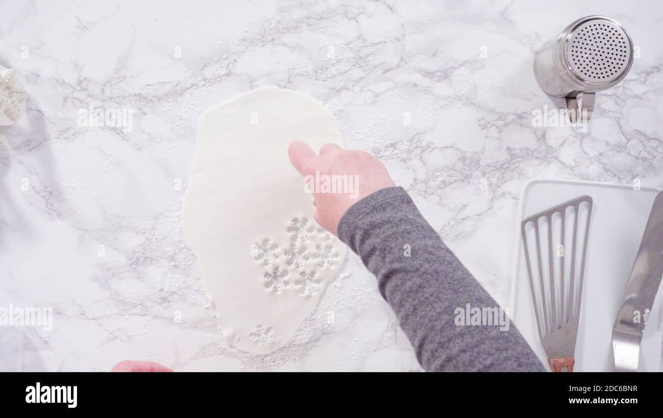 Flat lay. Step by step. Cutting out snowflakes with cookie cutters out ...