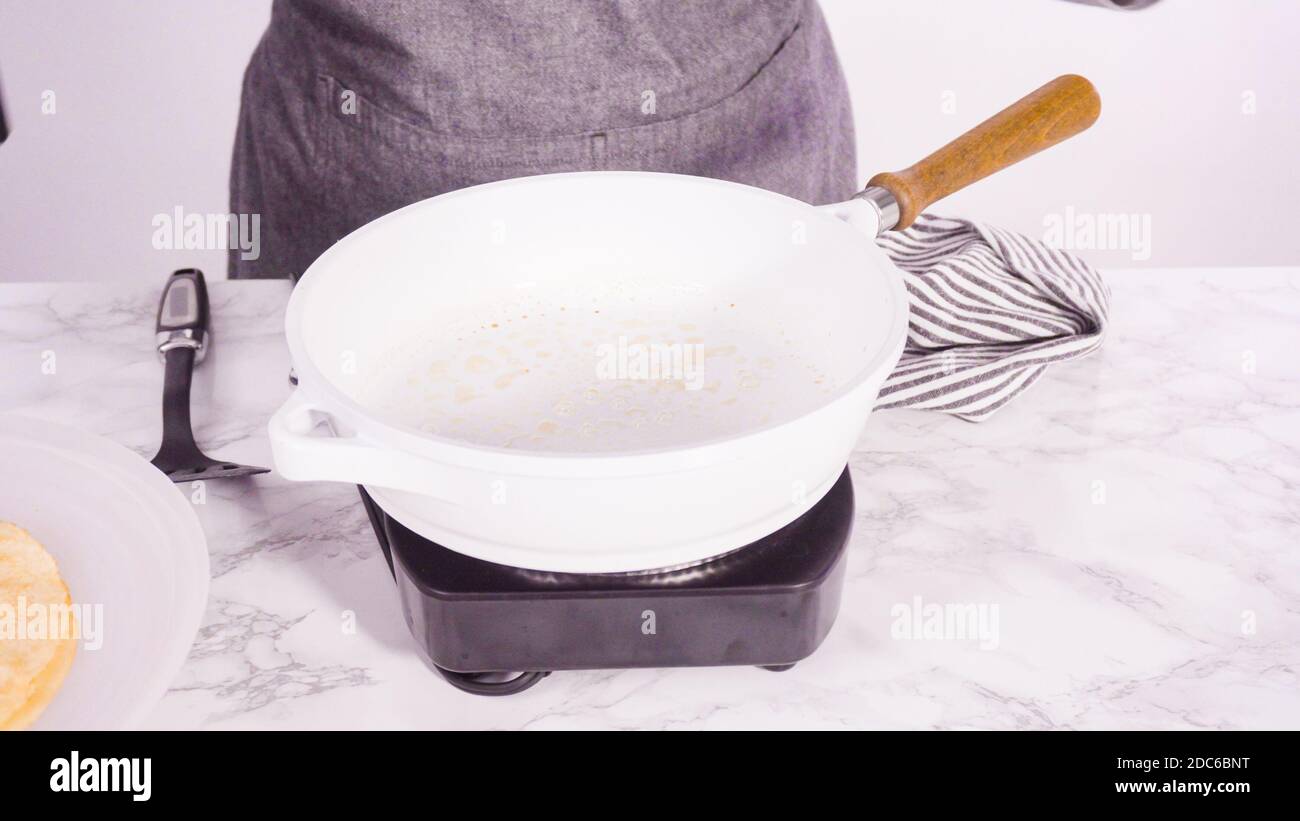 Making crepes in a small frying pan over medium heat Stock Photo - Alamy