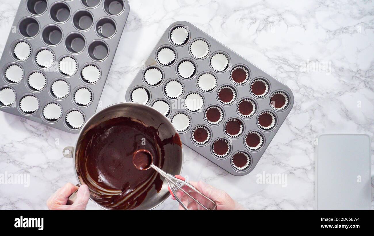 Flat lay. Step by step. Scooping cupcake batter into mini cupcake lines ...