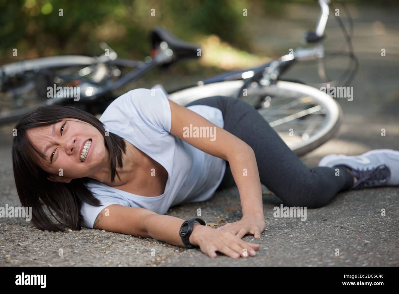 young woman fell from her bike Stock Photo - Alamy