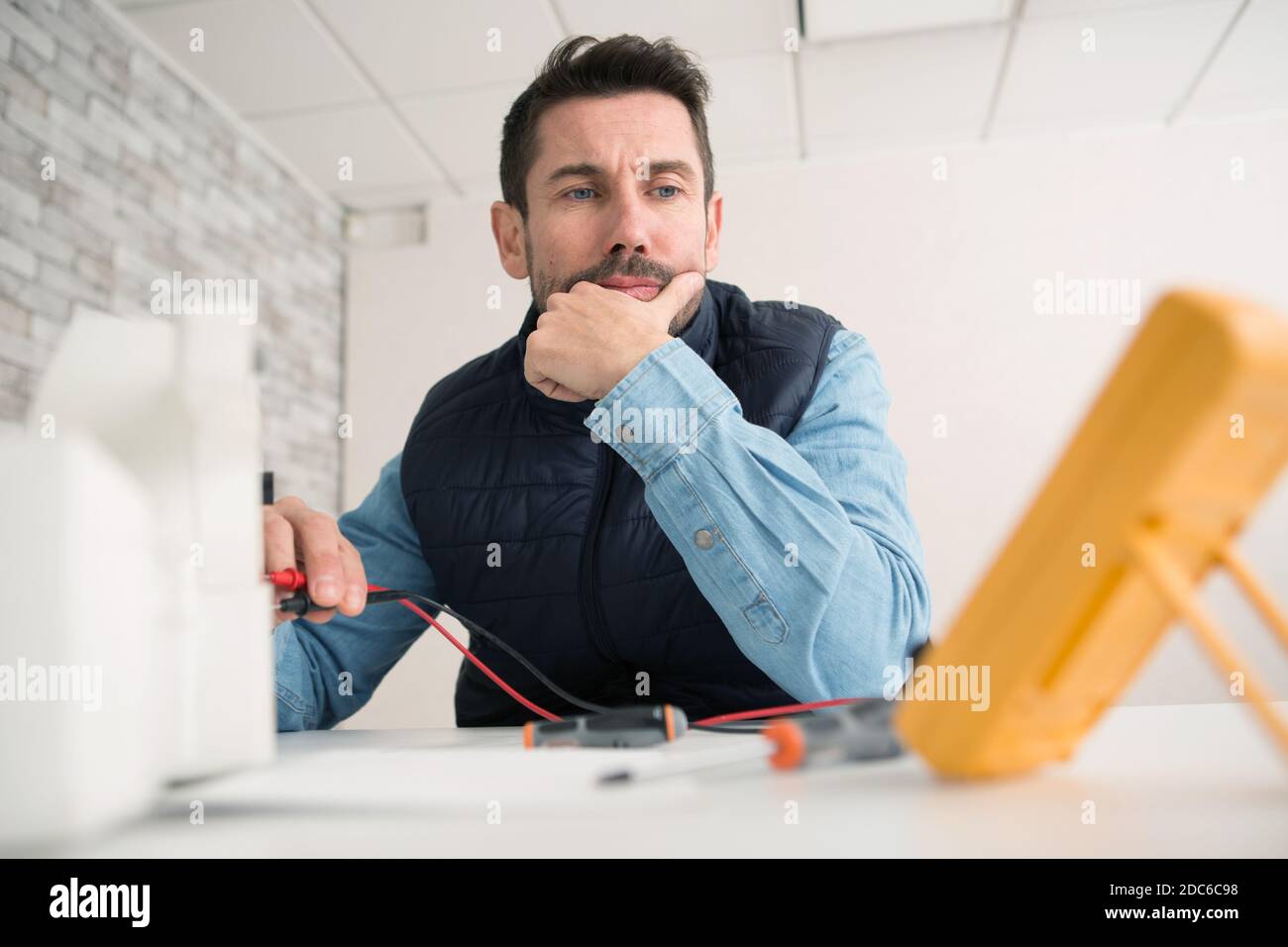 male technician using multimeter Stock Photo - Alamy