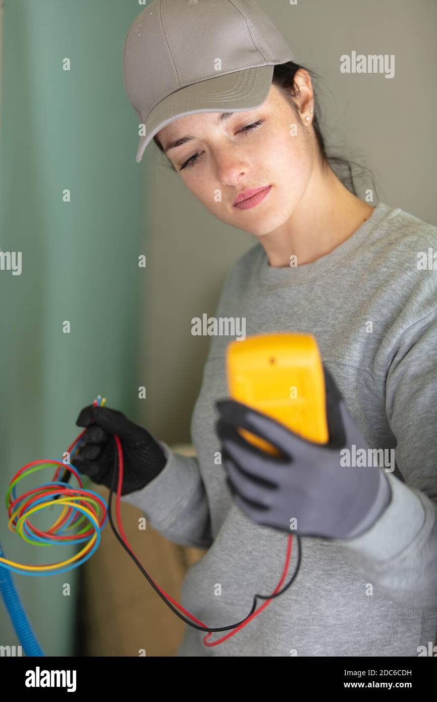 young woman measuring electrical current Stock Photo - Alamy