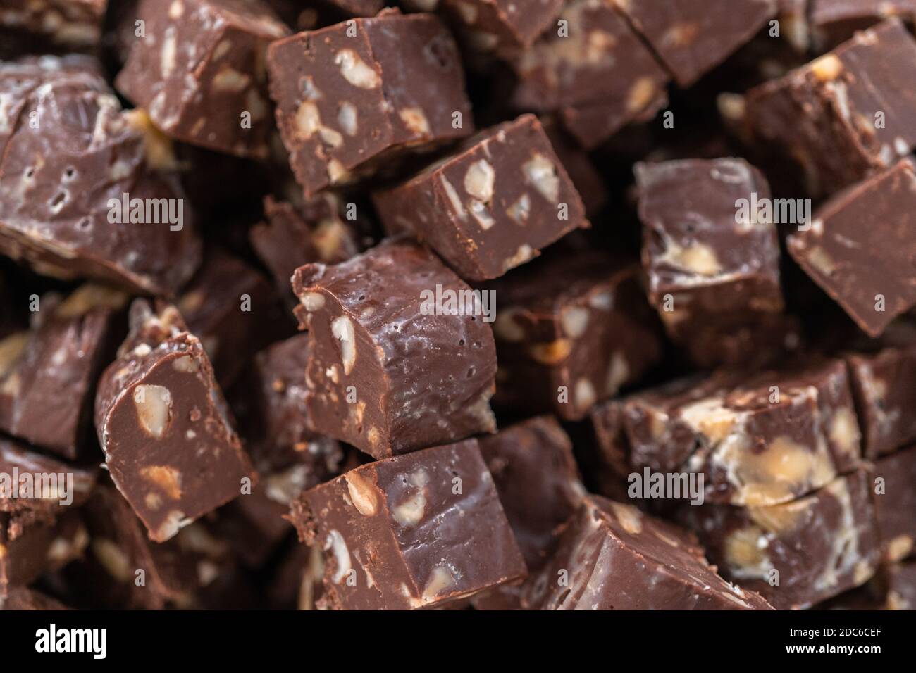 Cutting macadamia nut fudge into small cubes Stock Photo - Alamy
