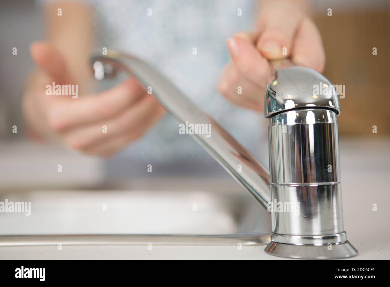 hand opens the water tap close up Stock Photo - Alamy