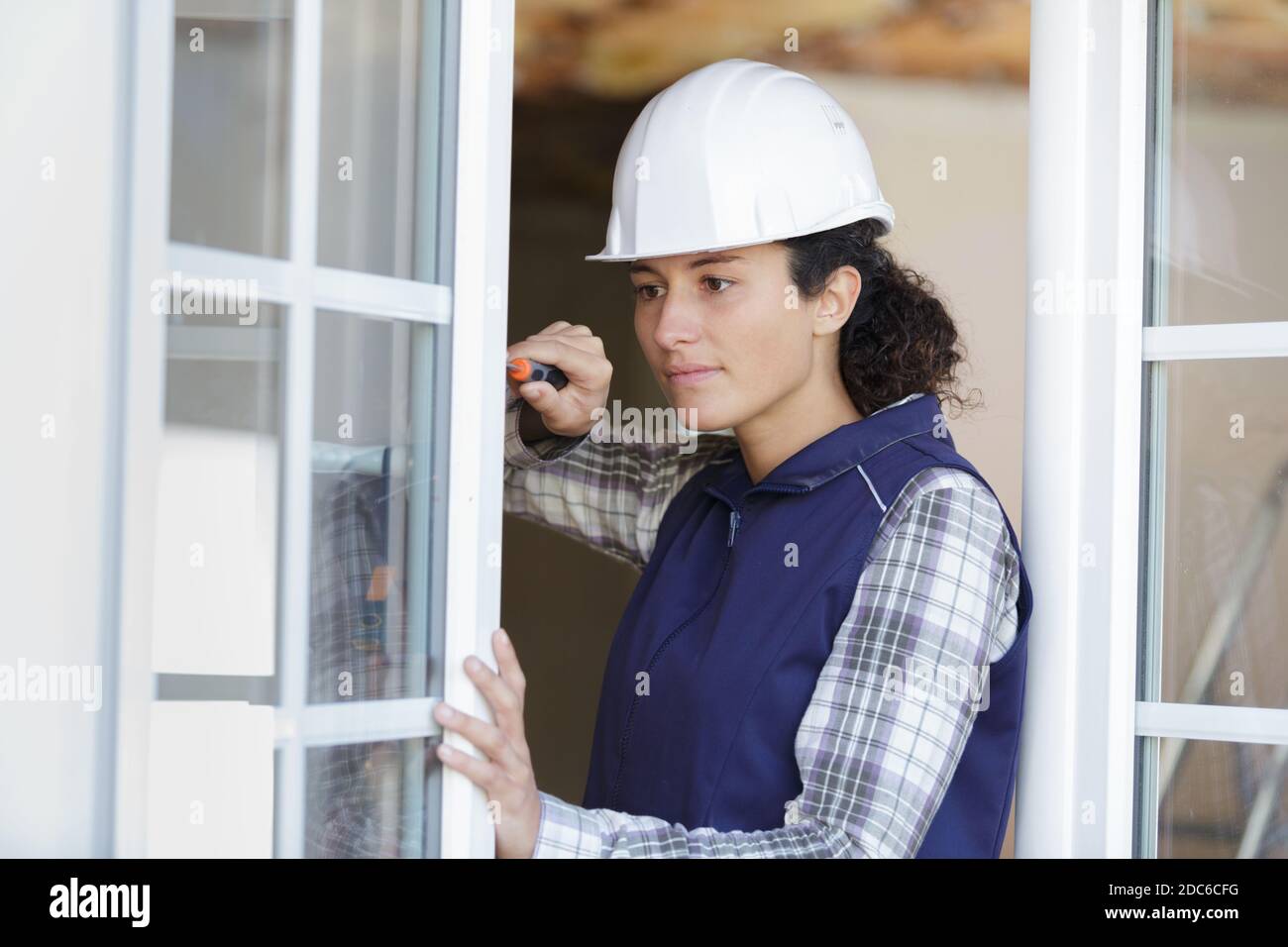 woman installing window handle with screwdriver indoors Stock Photo - Alamy
