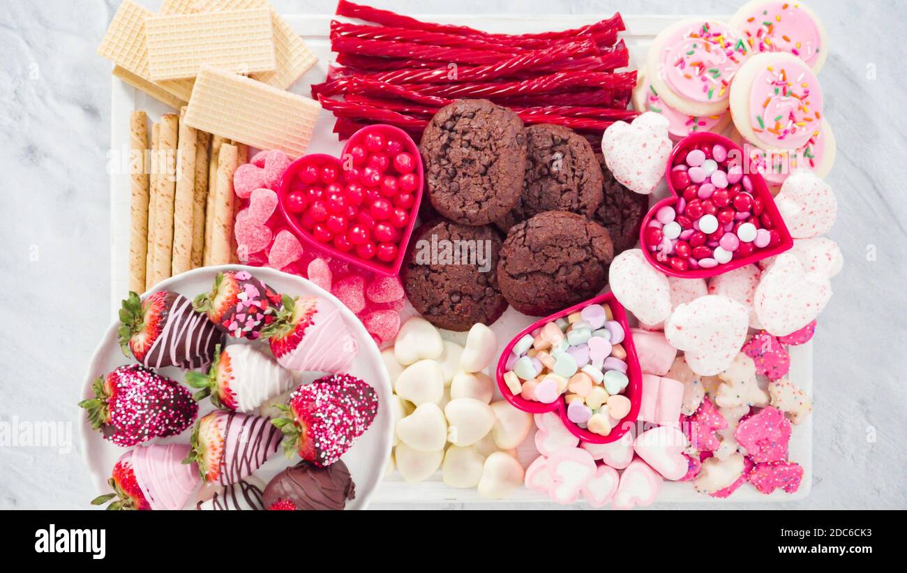 Flat lay. Step by step. Cheese board with candies and cookies for ...