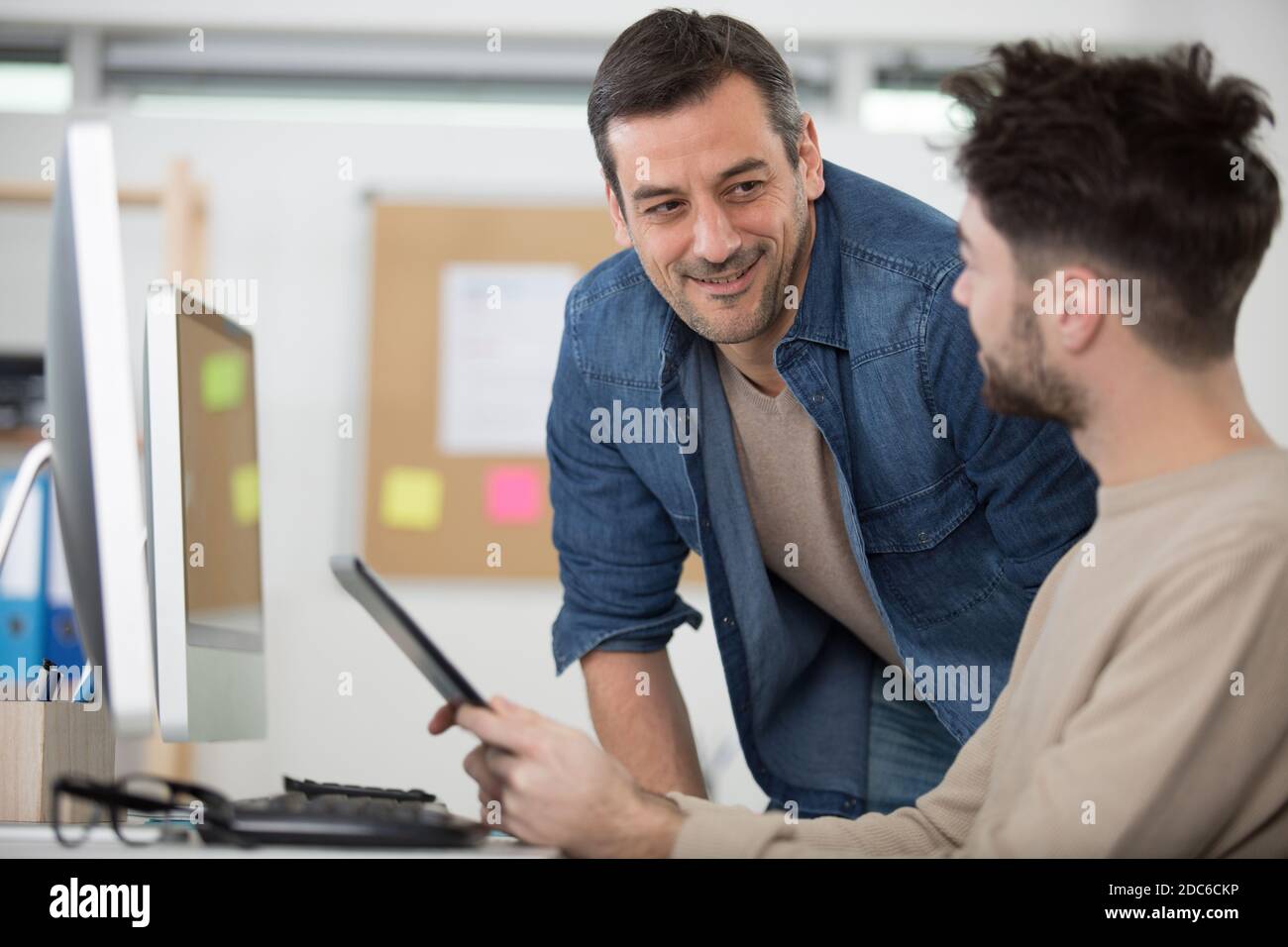 teacher working with male teenage pupil at computer Stock Photo - Alamy