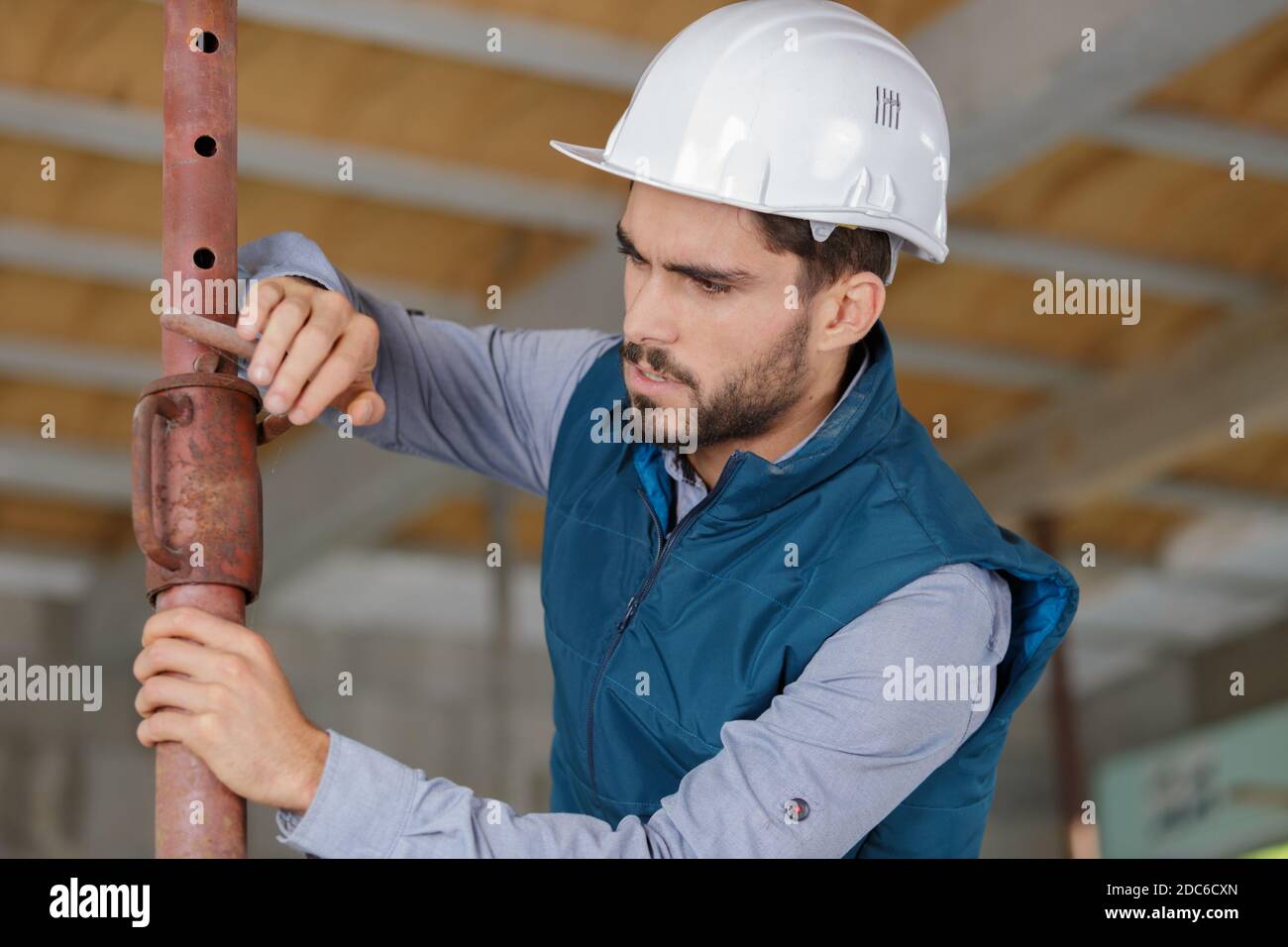 plumber at work installing pipes on construction site Stock Photo - Alamy
