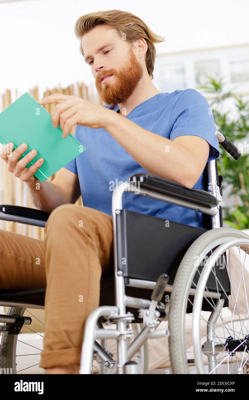 Disabled senior man reading book hi-res stock photography and images ...