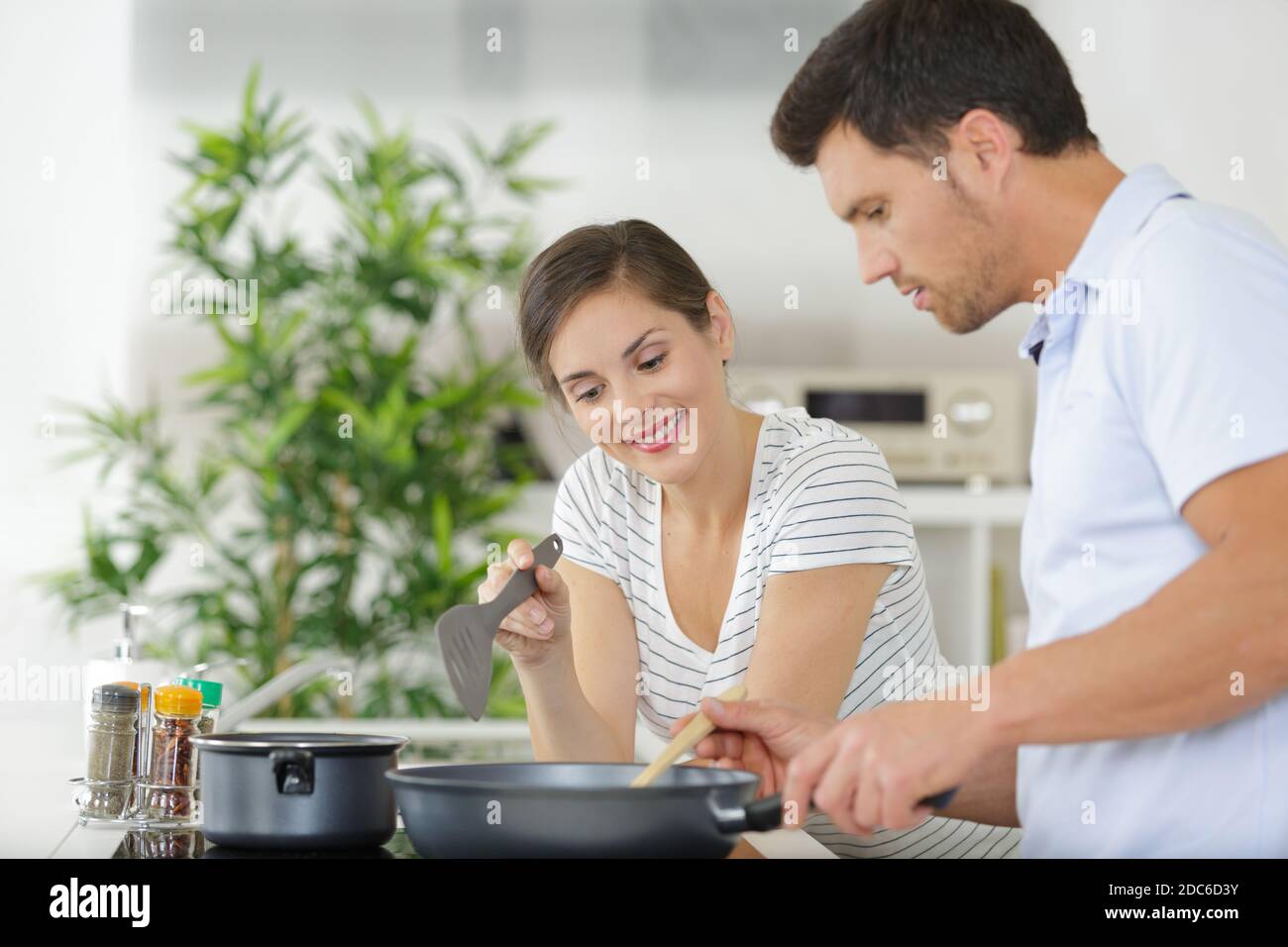 beautiful couple cooking in the kitchen Stock Photo - Alamy