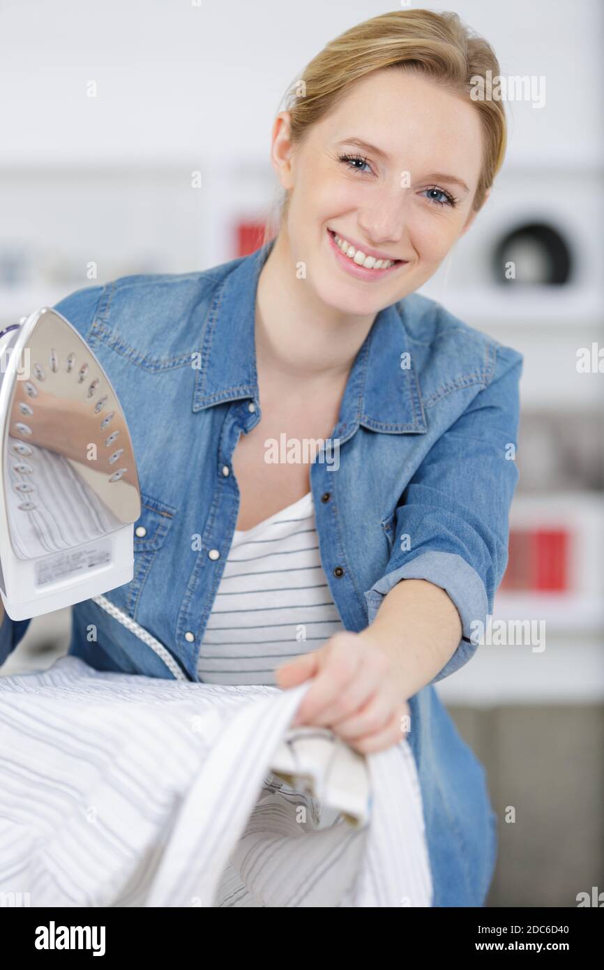happy woman irons at home Stock Photo - Alamy