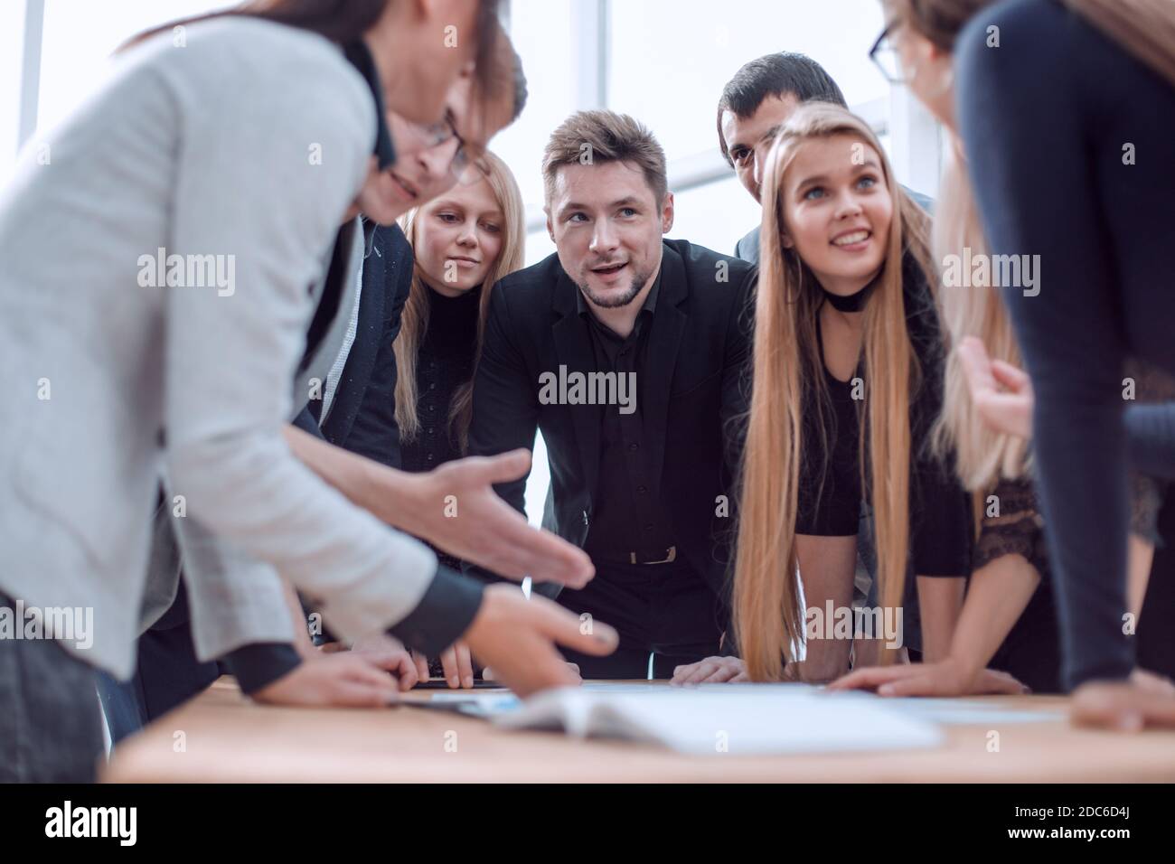 groups of employees standing near the desktop Stock Photo - Alamy