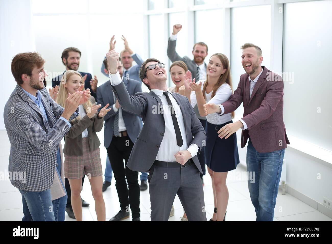 triumphant business team congratulating their leader. success concept ...